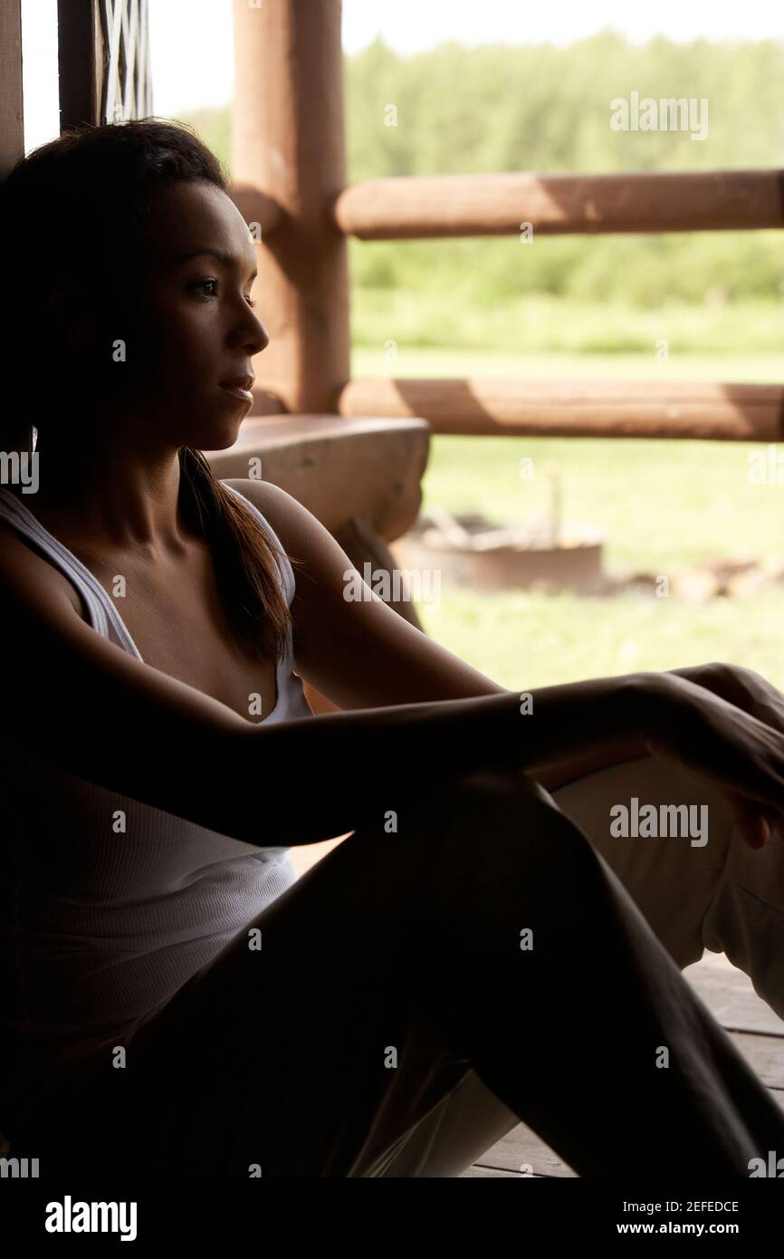 Side profile of a young woman sitting Stock Photo - Alamy