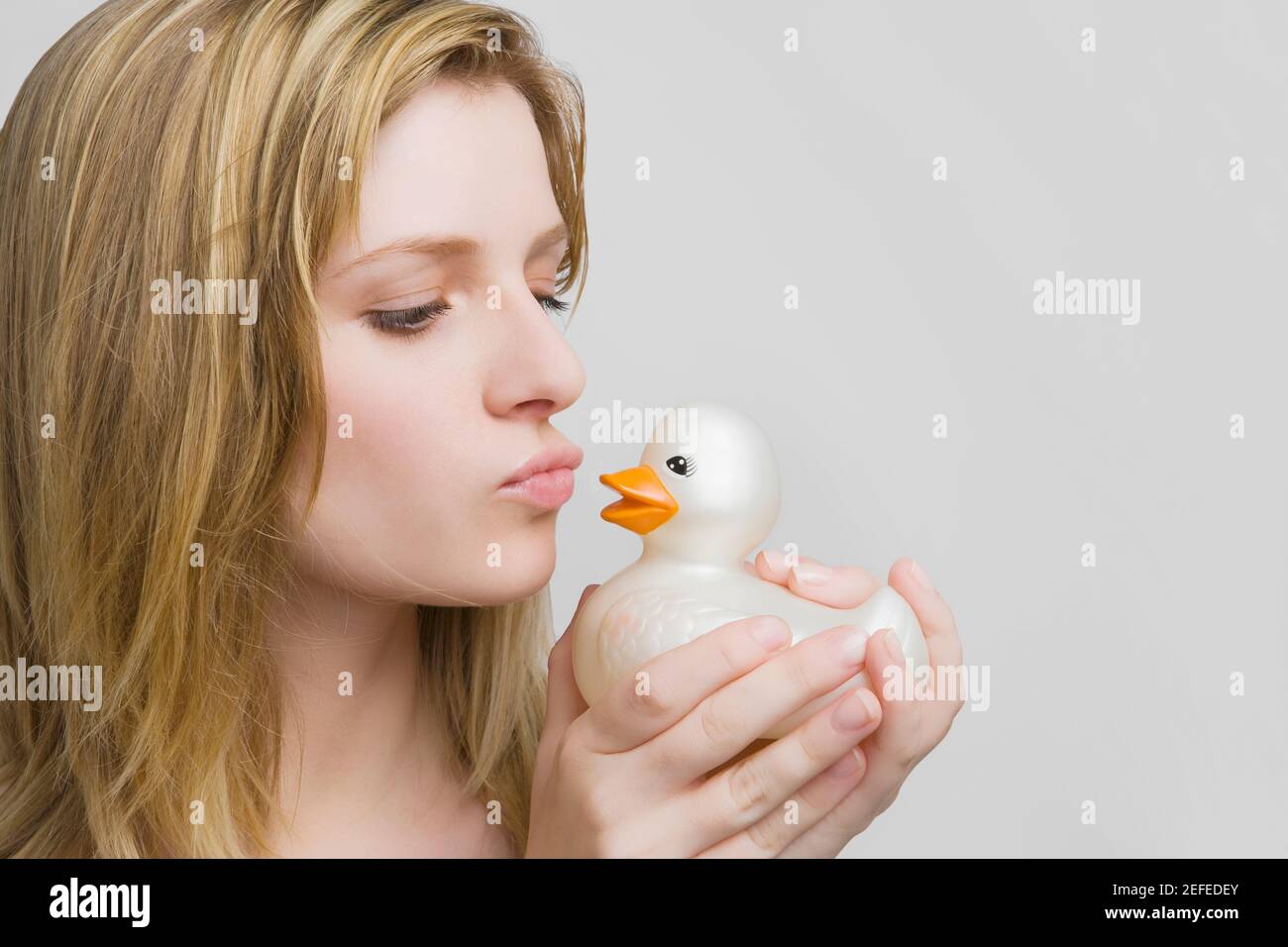 Close up of a teenage girl kissing a rubber duck Stock Photo - Alamy