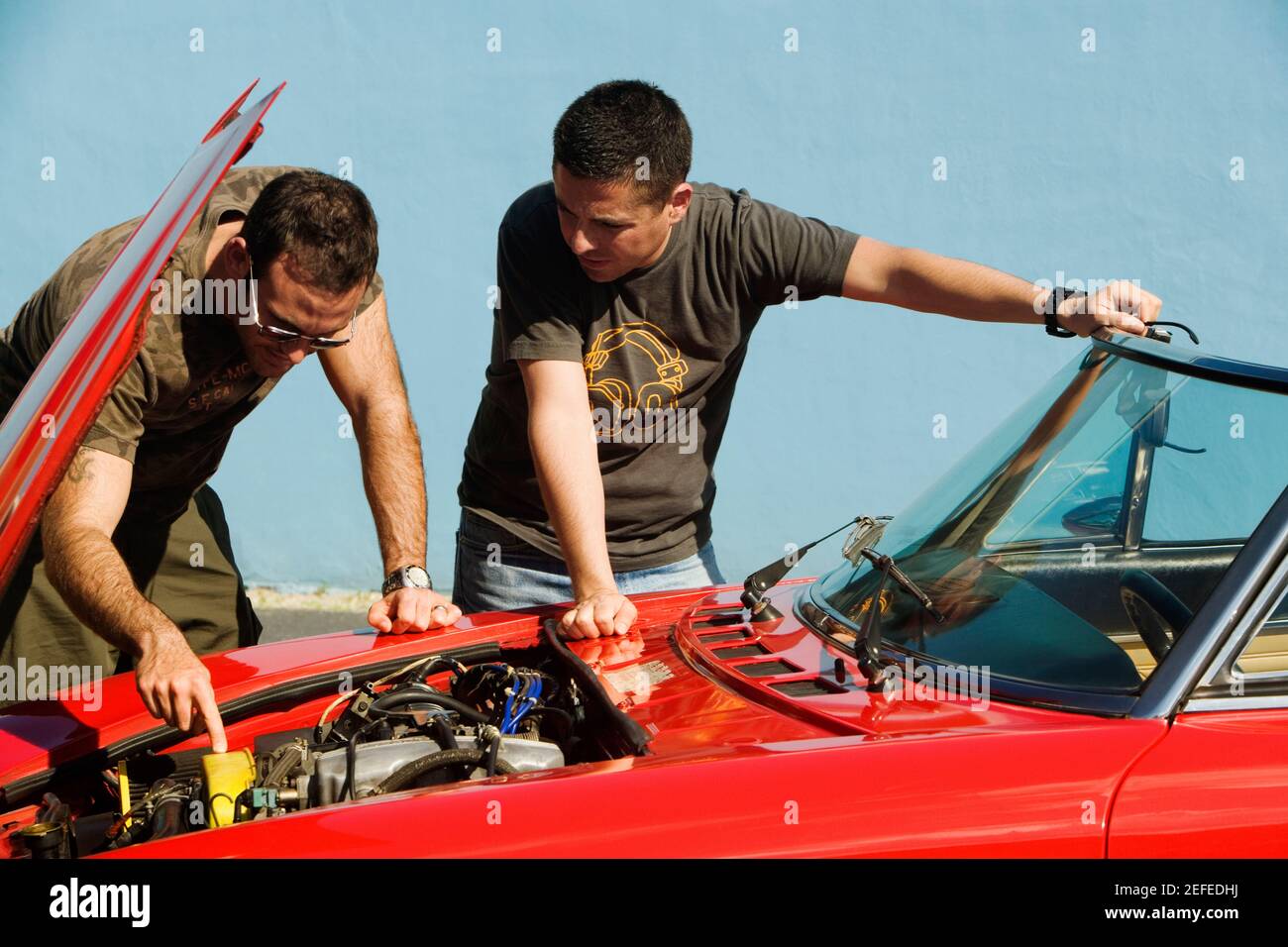 Two mid adult men examining a car engine, Miami, Florida, USA Stock ...