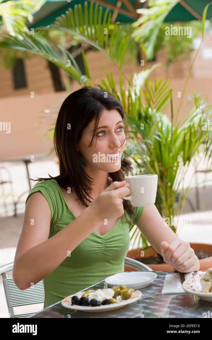 Close-up of a teenage girl drinking tea at a restaurant Stock Photo - Alamy