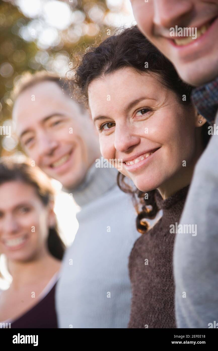 Side profile of two couples standing together and smiling Stock Photo ...
