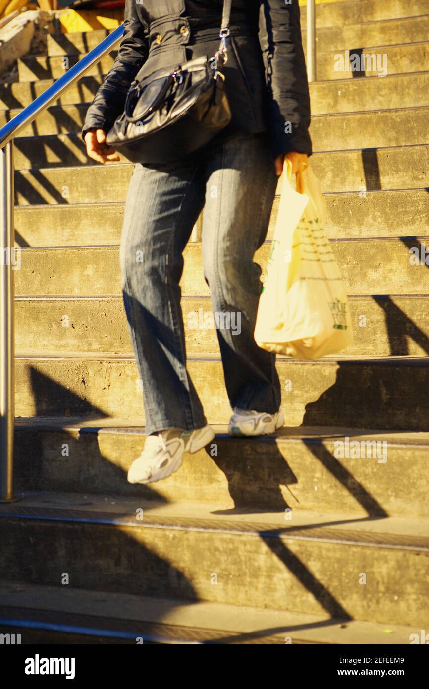 Low section view of a man walking down stairs Stock Photo - Alamy