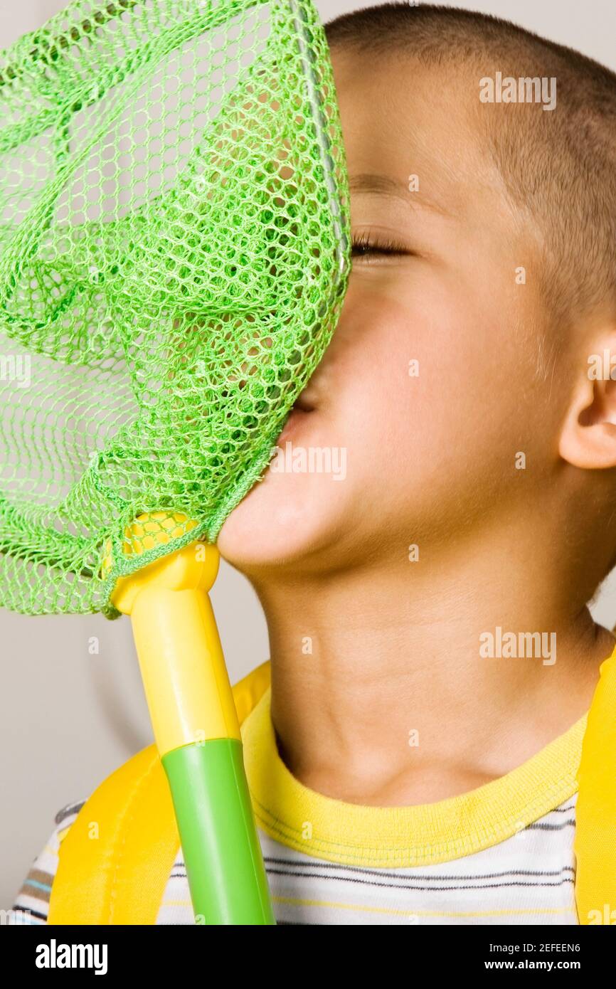 Close-up of a boy with a butterfly net Stock Photo - Alamy