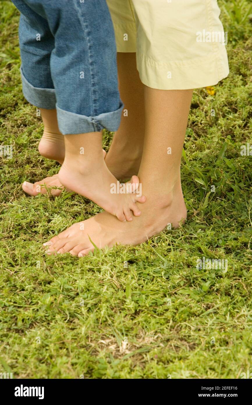 Low section view of a child feet on an adultÅ½s feet Stock Photo - Alamy
