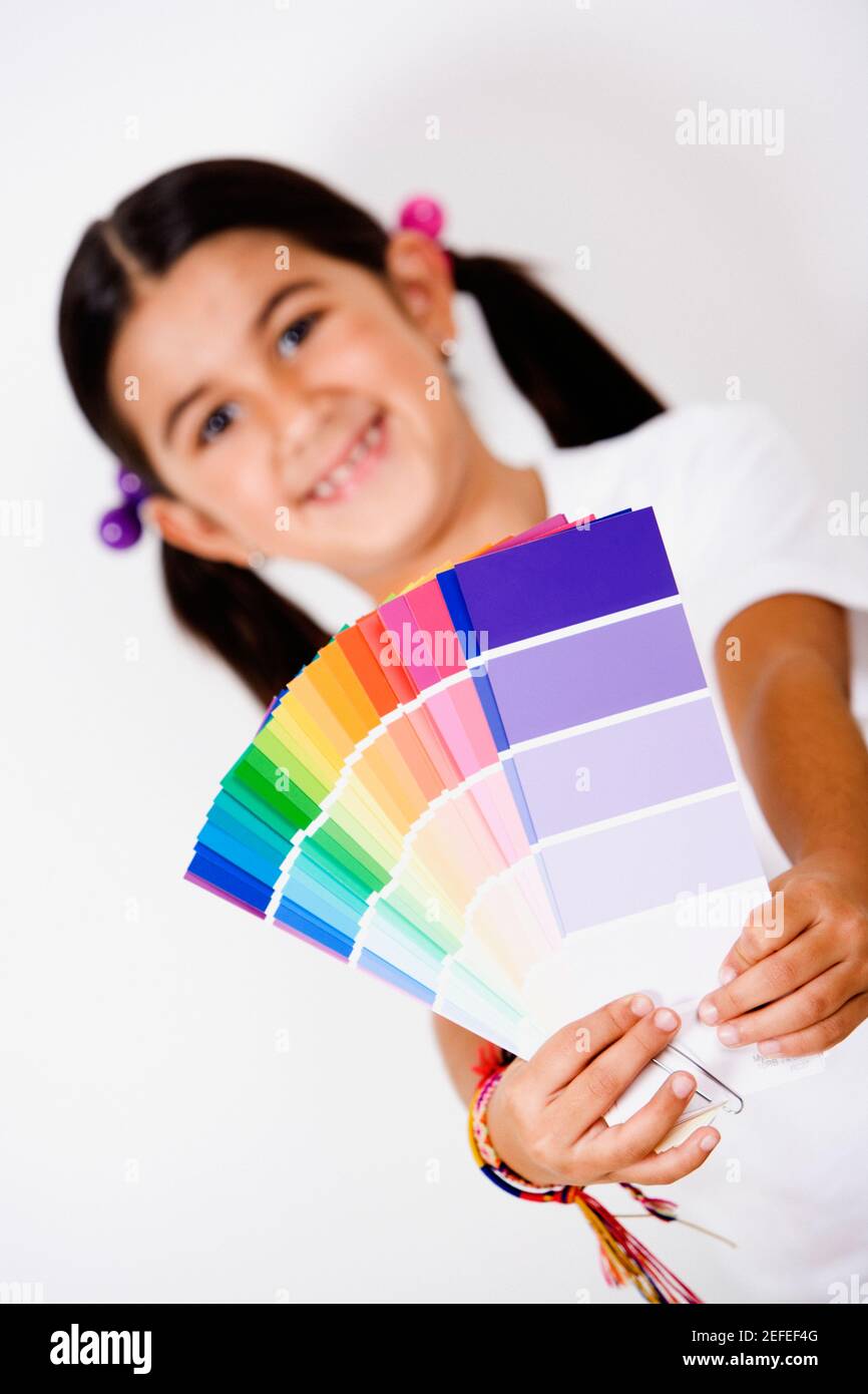 Portrait of a girl holding color swatches Stock Photo - Alamy