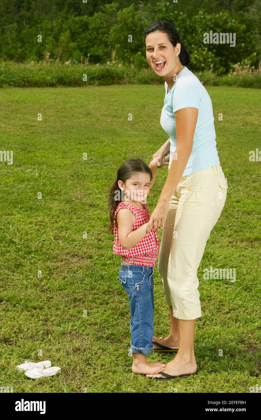 Side profile of a mother and her daughter smiling Stock Photo - Alamy