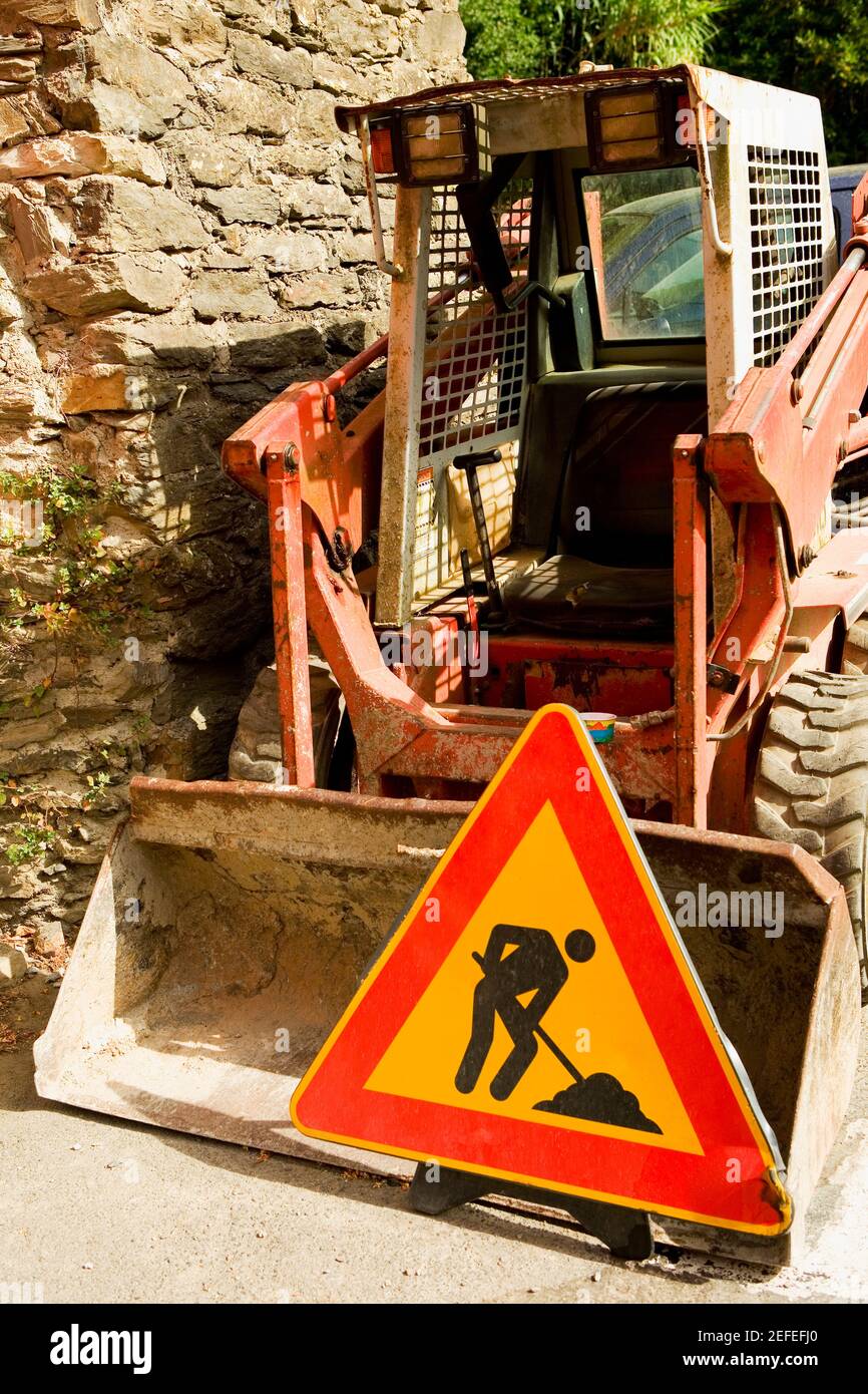 Road construction sign near an earth mover, Vernazza, La Spezia ...