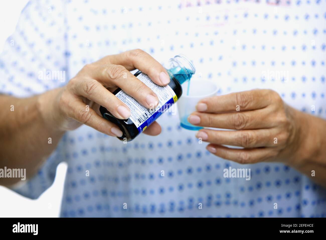 Mid section view of a woman pouring syrup in to a measuring cup Stock ...