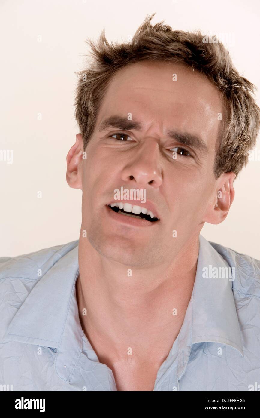 Portrait of a young man looking confused Stock Photo - Alamy