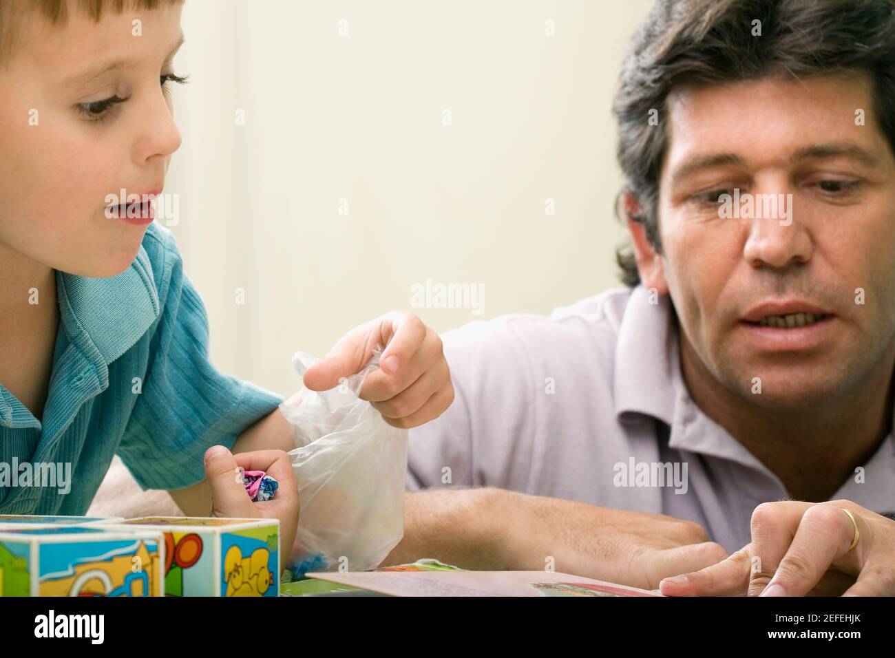 Male teacher teaching his student in a classroom Stock Photo - Alamy