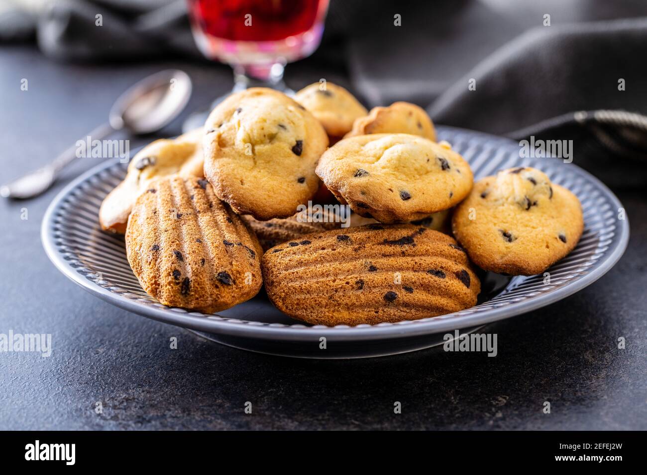 Madeleine with chocolate. Traditional French small cakes on plate Stock ...