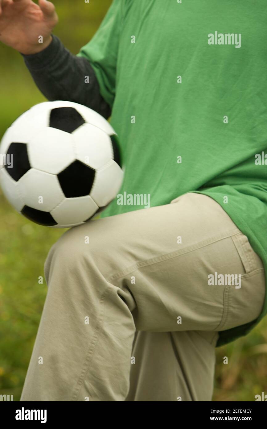 Mid section view of a man playing with a soccer ball Stock Photo - Alamy
