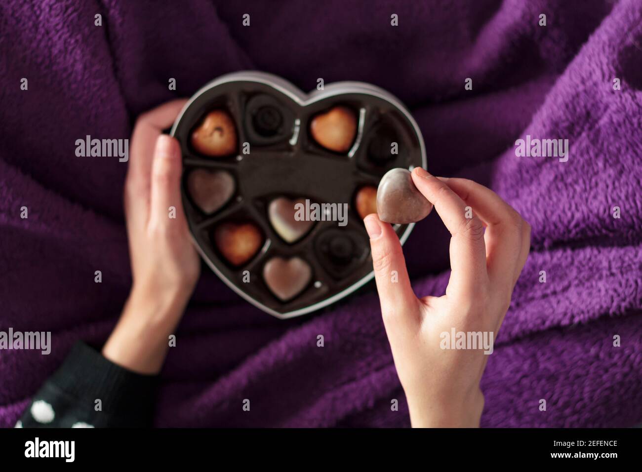 Woman eating chocolates hi-res stock photography and images - Alamy