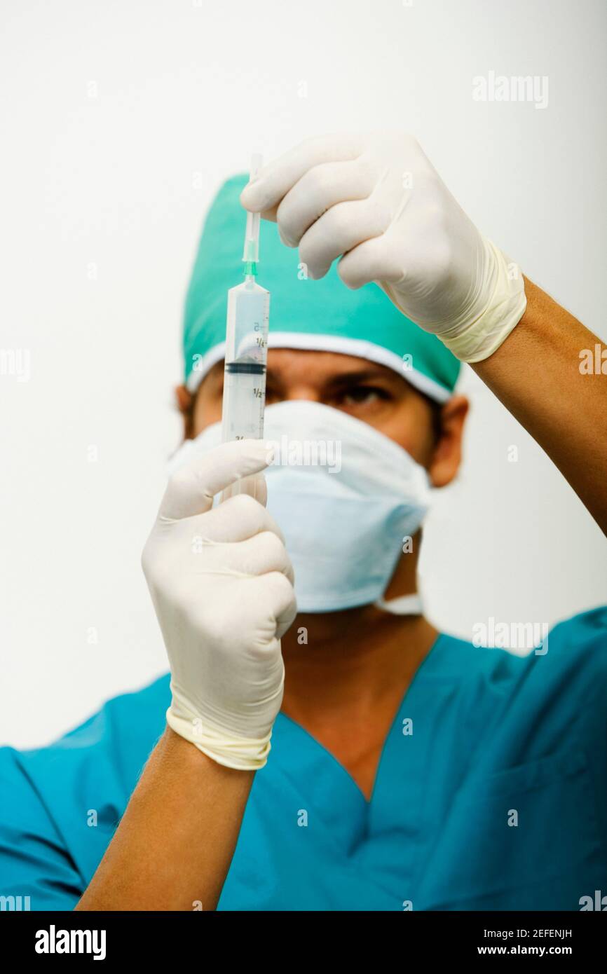 Close-up of a male surgeon holding a syringe Stock Photo - Alamy