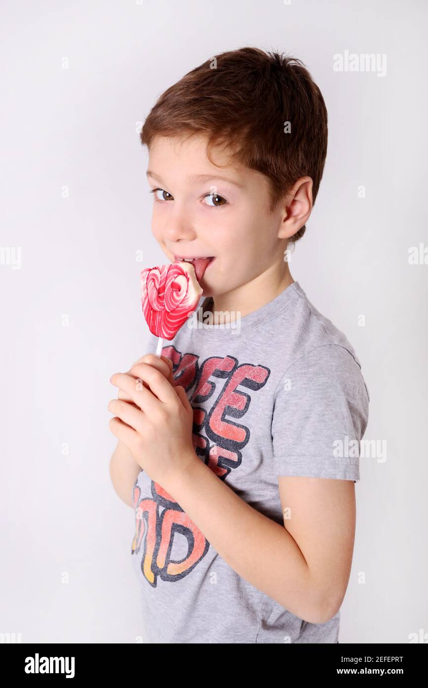 Little boy with sweet pink candy Stock Photo - Alamy