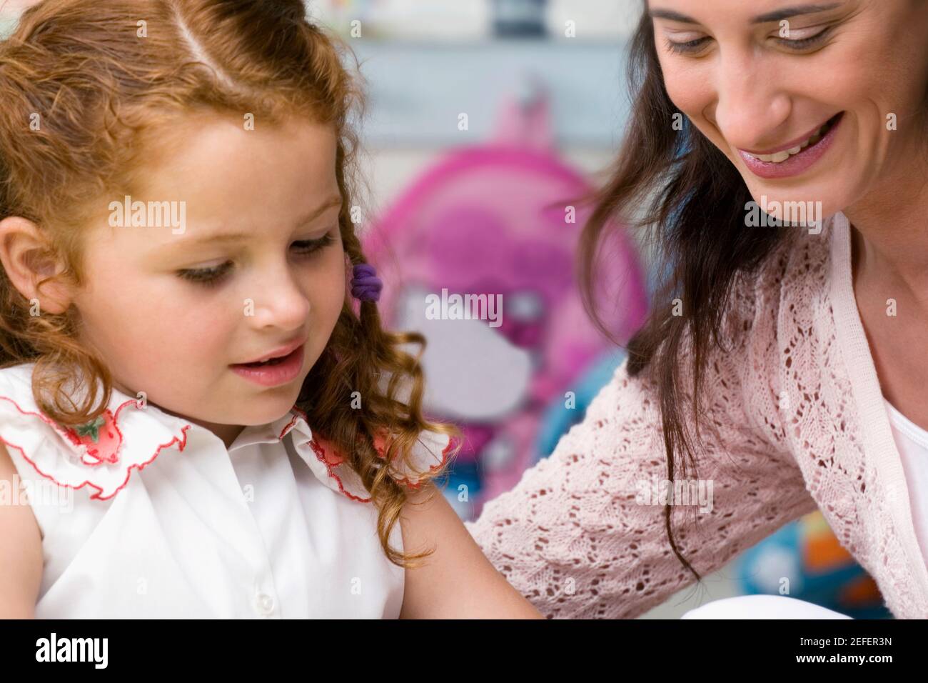 Female teacher teaching her student in a classroom Stock Photo - Alamy