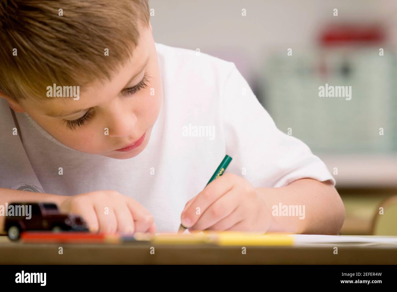 Close up of a boy drawing on a sheet of paper Stock Photo - Alamy