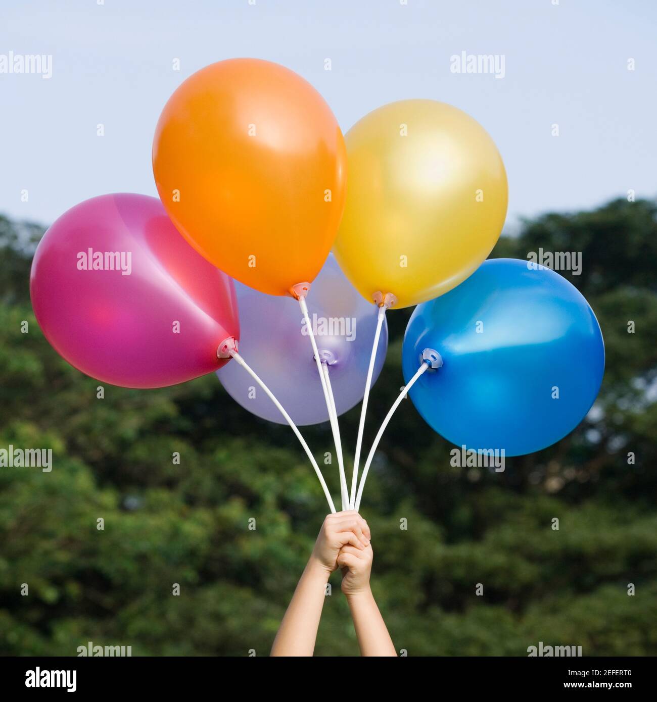 Hand holding balloons hi-res stock photography and images - Alamy