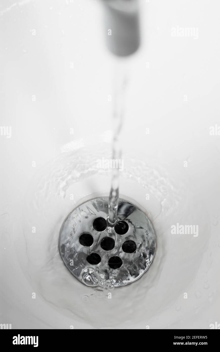 Water flowing out of a faucet Stock Photo - Alamy