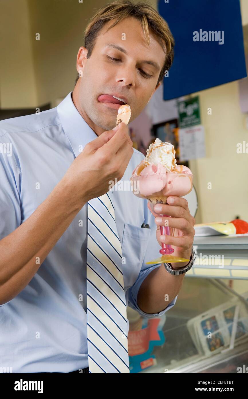 Mid adult man eating an ice cream Stock Photo - Alamy