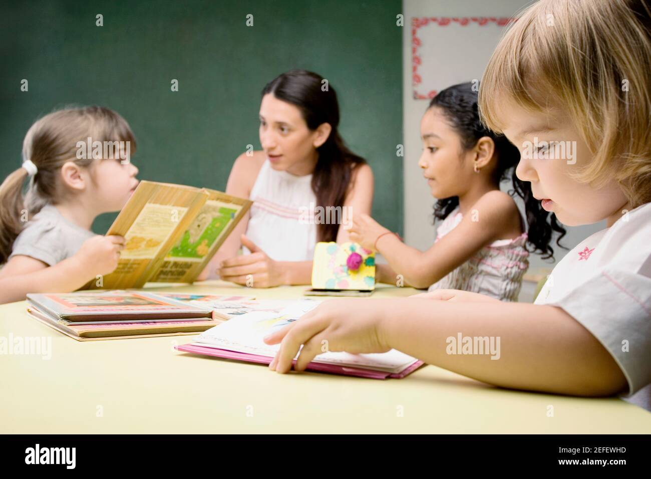 Female teacher teaching her students in a classroom Stock Photo - Alamy
