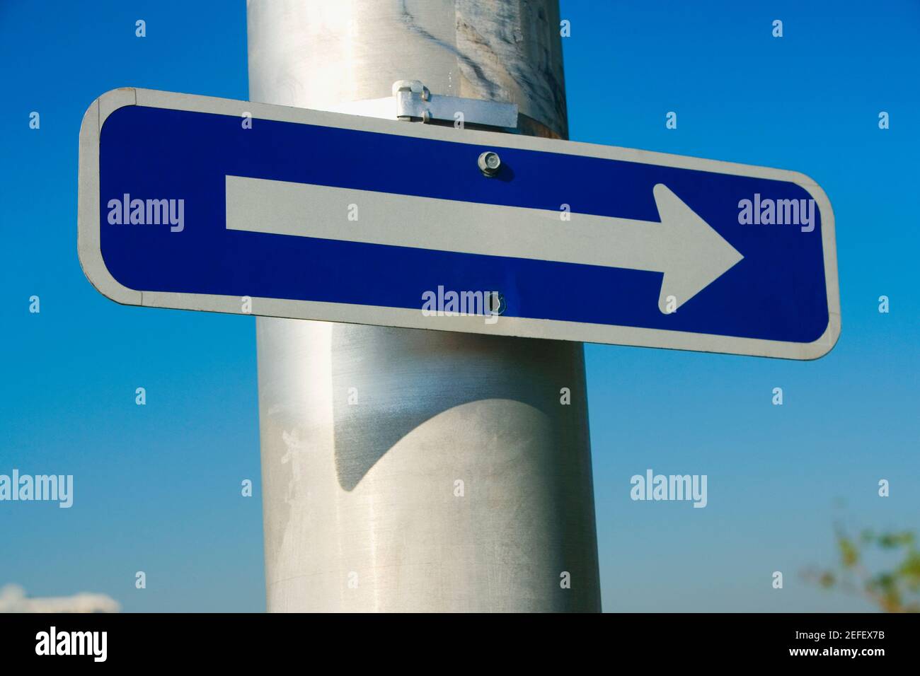 Close-up of an arrow sign on a pole Stock Photo - Alamy