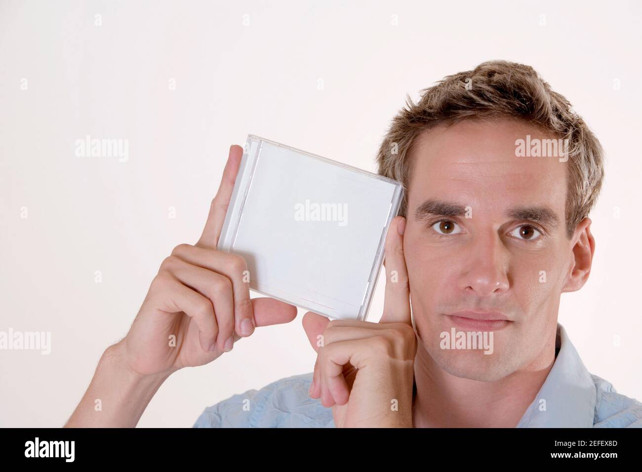 Portrait of a mid adult man holding a CD case Stock Photo - Alamy