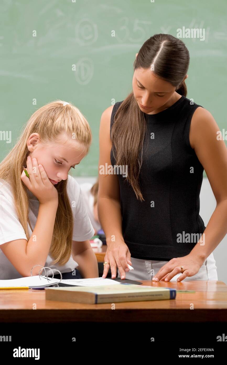 Female teacher teaching a schoolgirl in a classroom Stock Photo - Alamy