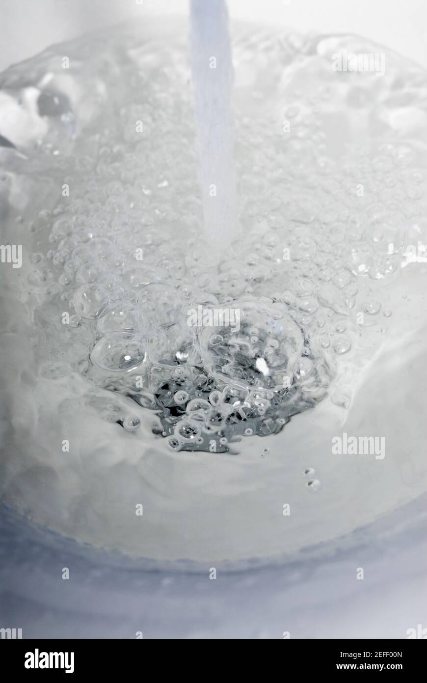 Water flowing out of a faucet Stock Photo - Alamy