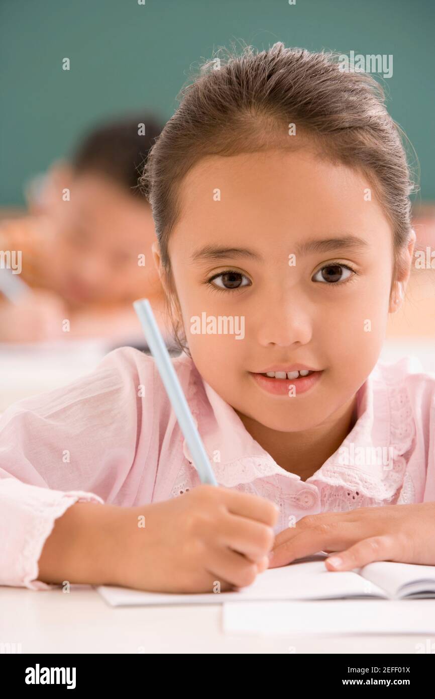 Portrait of a girl studying in a classroom Stock Photo - Alamy