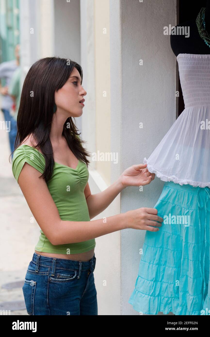 Side profile of a teenage girl at a clothing store Stock Photo - Alamy