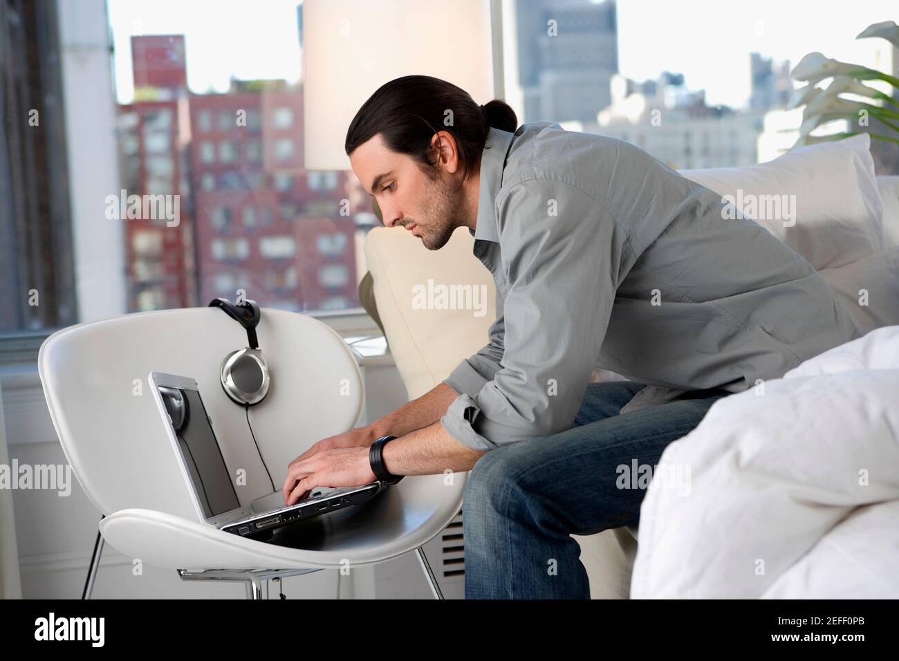 Side profile of a young man using a laptop Stock Photo - Alamy