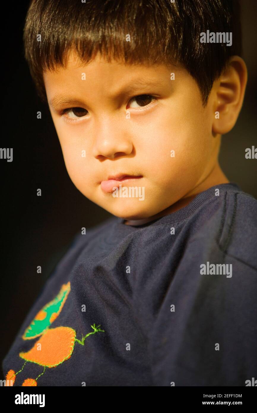 Portrait of a boy biting his lip Stock Photo - Alamy