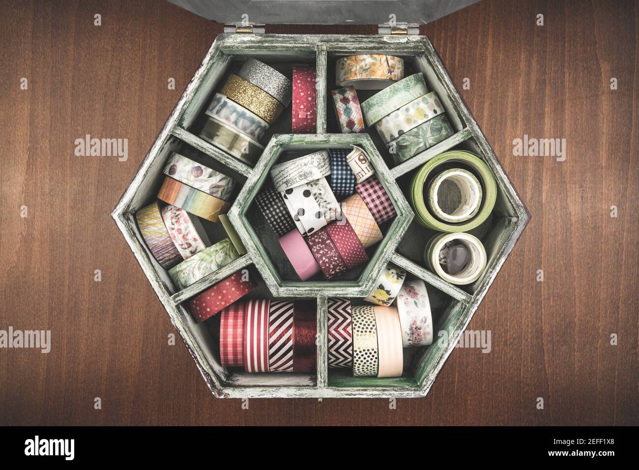 A top view of colorful various washi tape rolls collection in a vintage ...