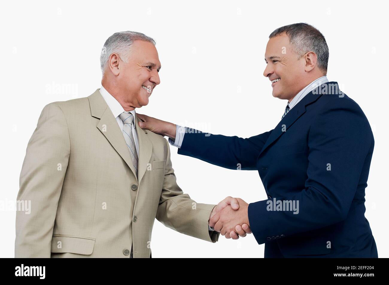 Two businessmen shaking hands and smiling Stock Photo - Alamy