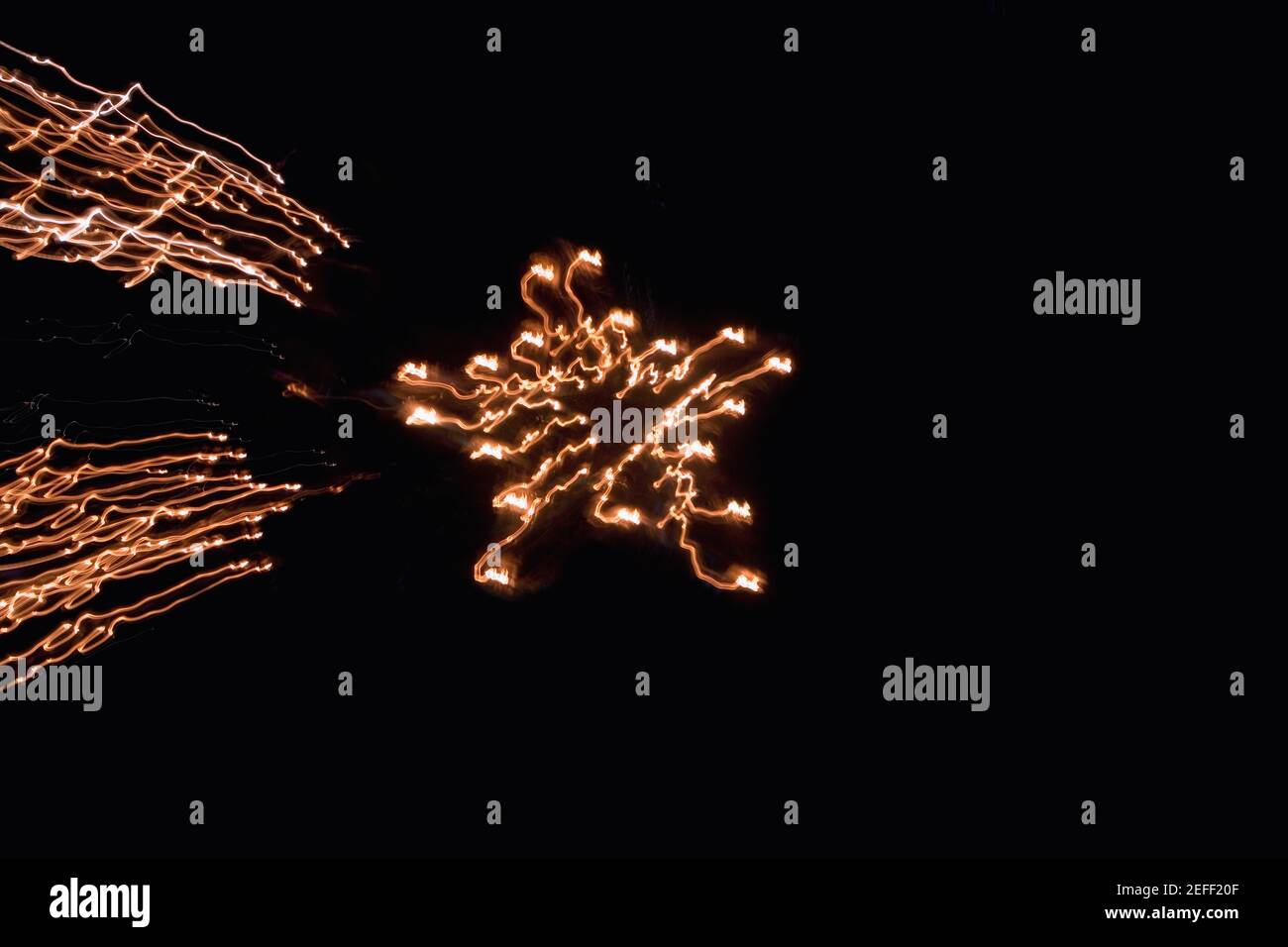 Low angle view of fire crackers exploding in the night sky Stock Photo ...