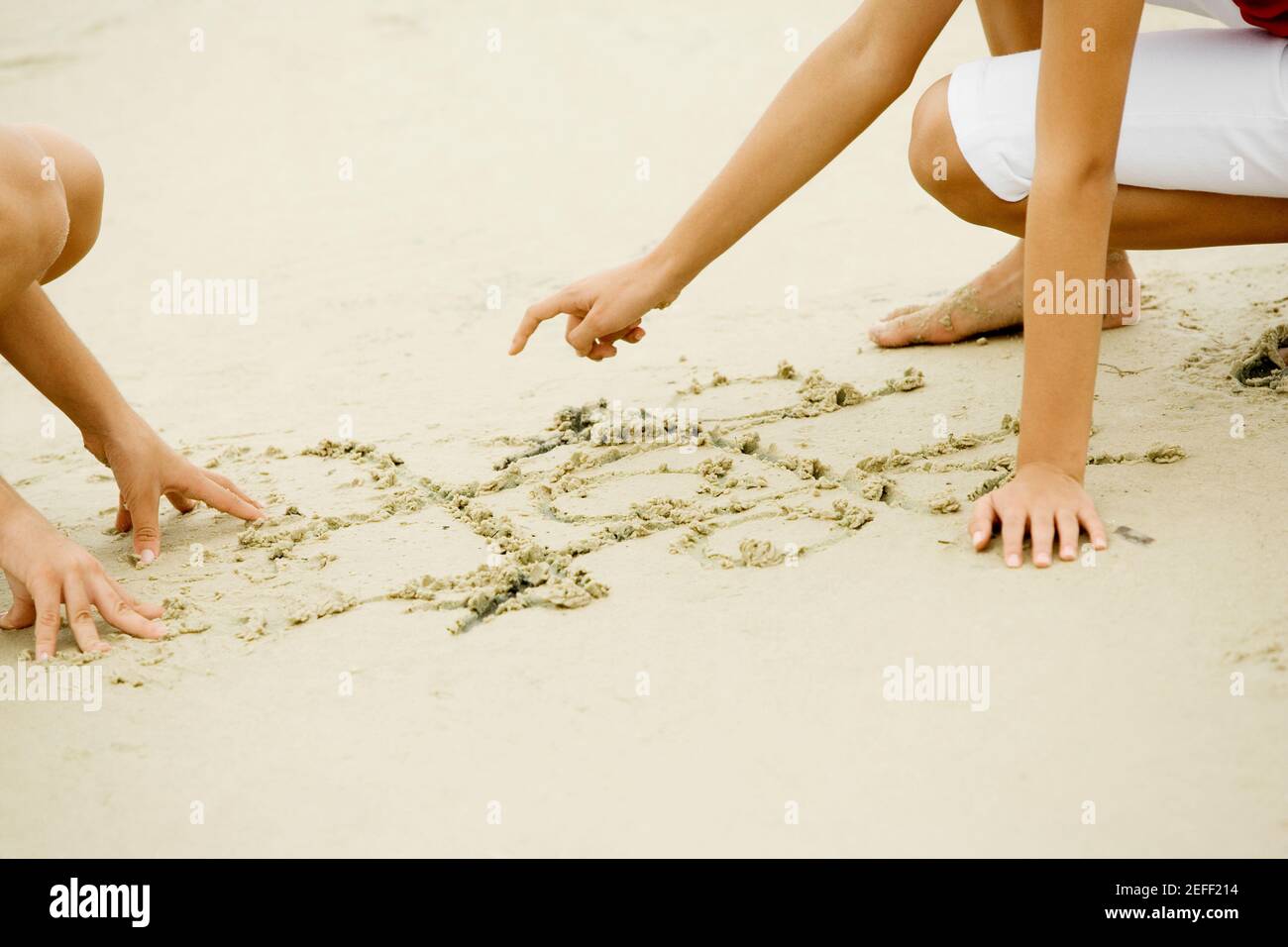 Children drawing in the sand hi-res stock photography and images - Alamy