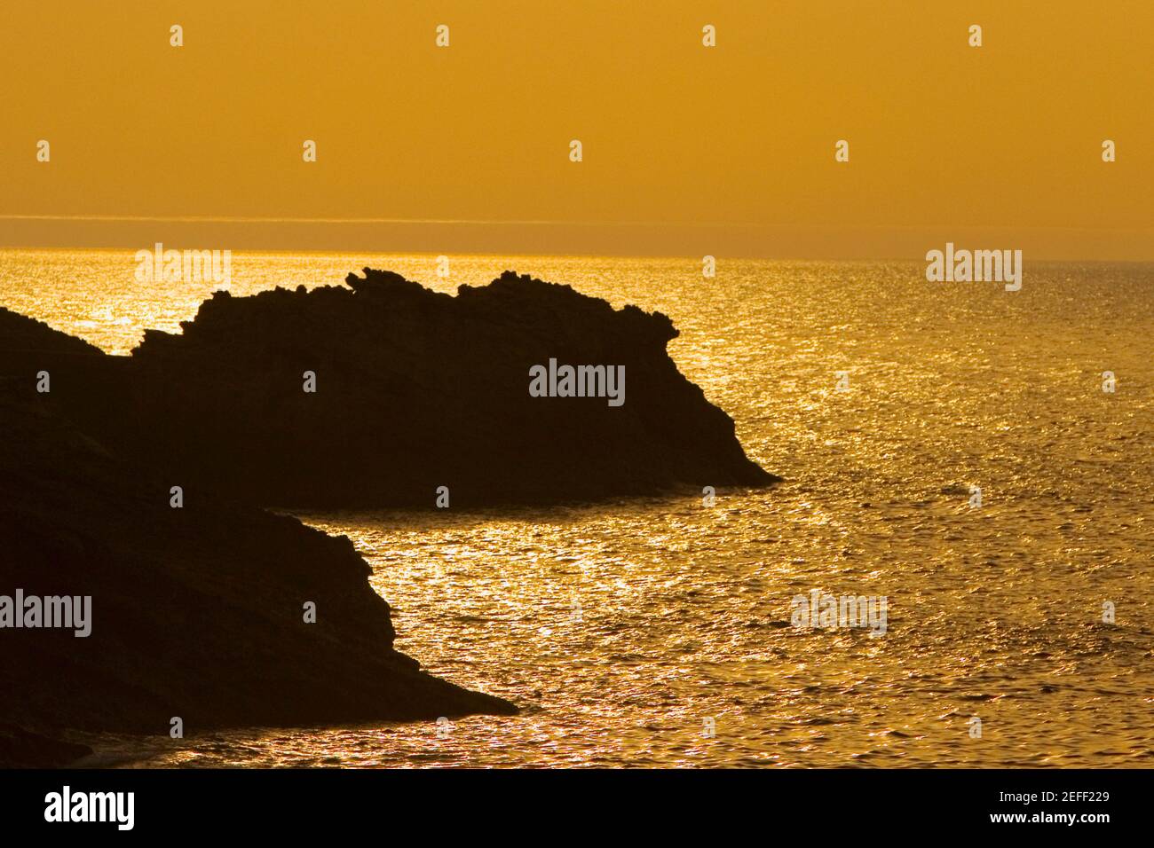 Silhouette of rock formations in the sea at dusk, Biarritz, Basque ...