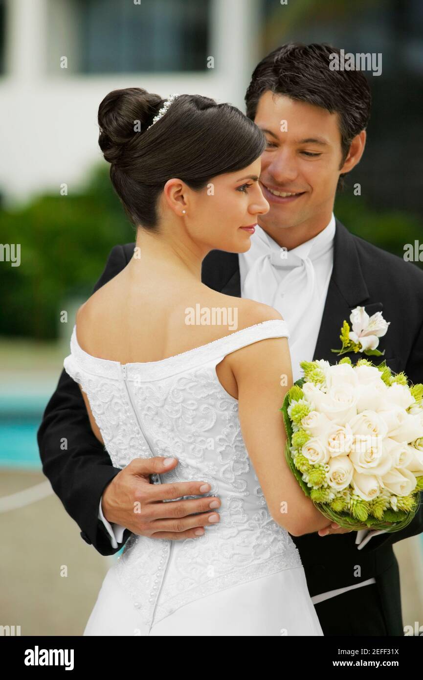 Close-up of a groom embracing his bride Stock Photo - Alamy