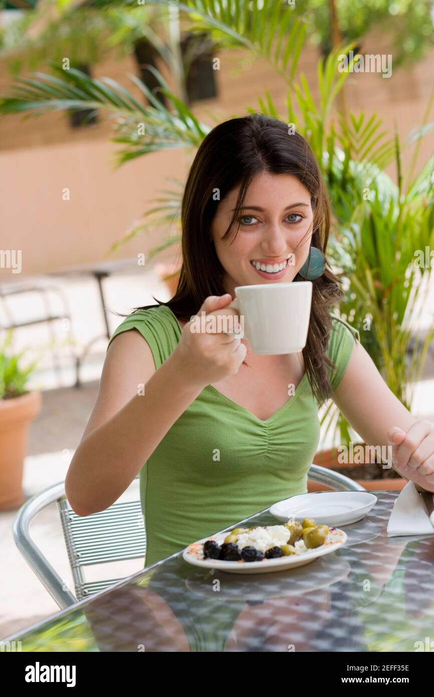 Portrait of a teenage girl drinking tea at a restaurant Stock Photo - Alamy
