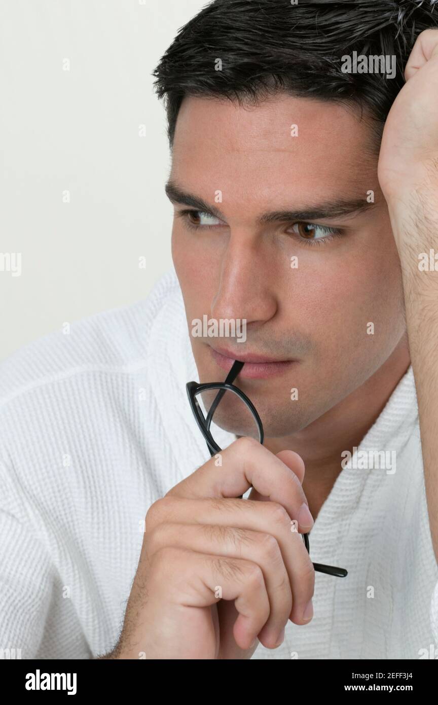 Close-up of a young man thinking Stock Photo - Alamy