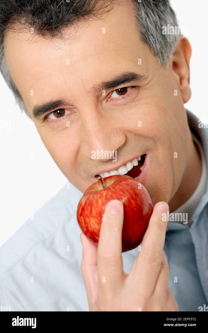 Portrait of a mid adult man eating an apple Stock Photo - Alamy