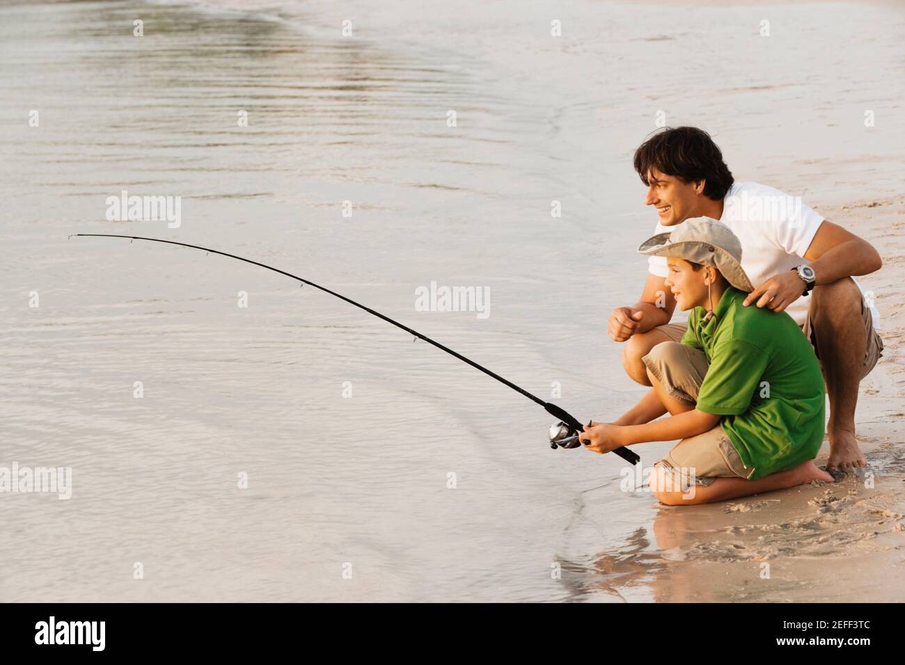 Side profile of a father and his son fishing Stock Photo - Alamy