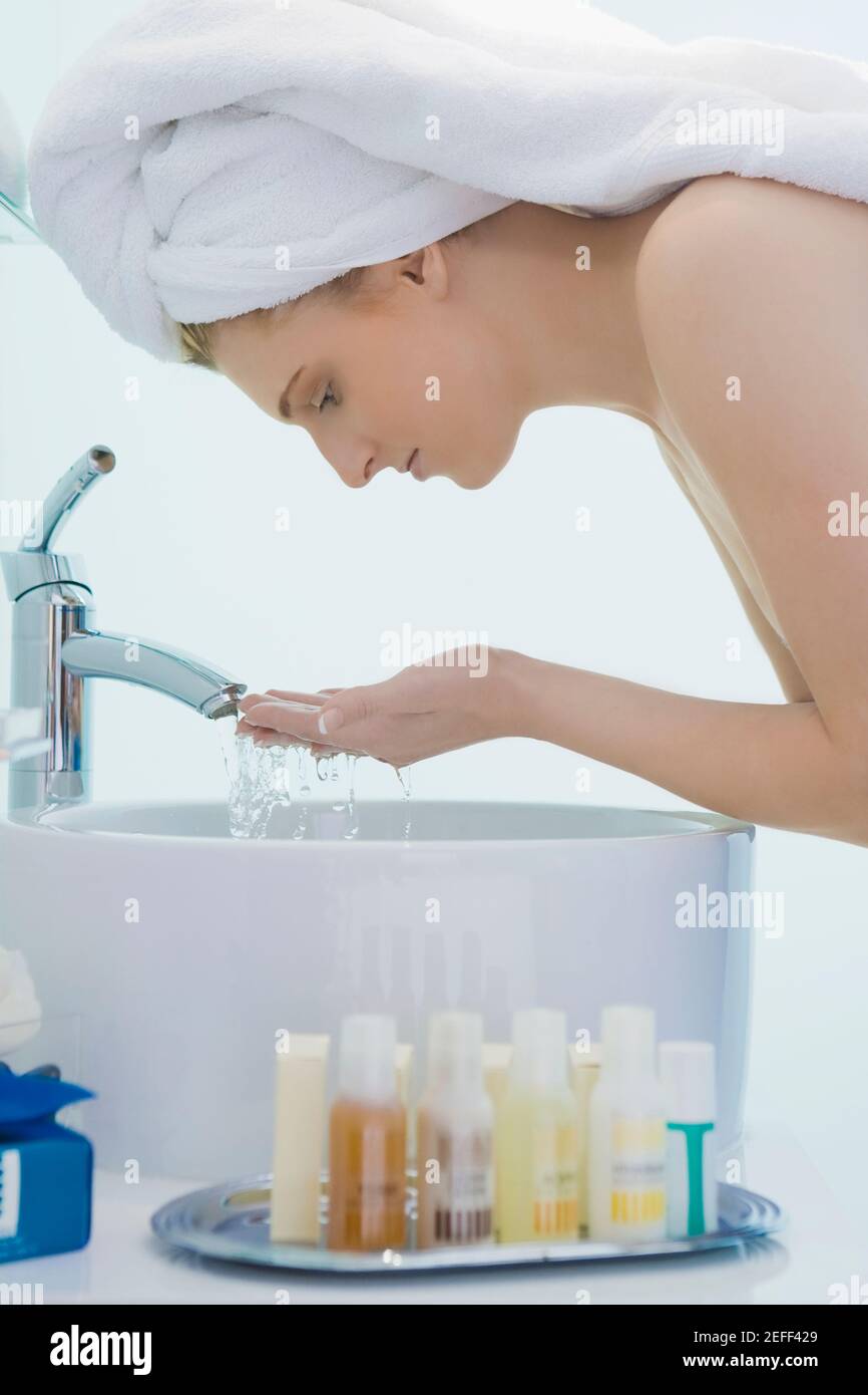 Woman washing her face and side view hi-res stock photography and ...