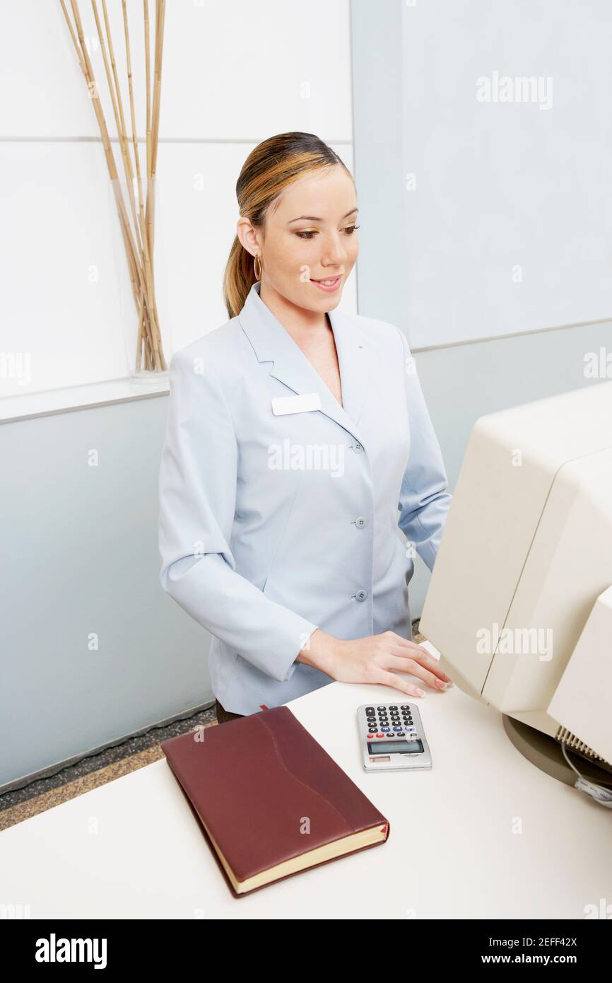 High angle view of a female receptionist using a computer Stock Photo ...