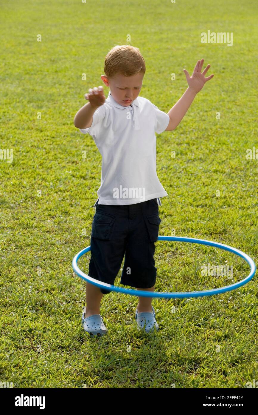Boy playing with a plastic hoop Stock Photo - Alamy