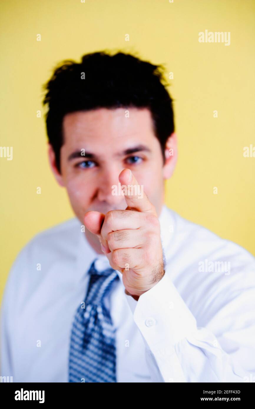 Portrait of a businessman pointing forward with his finger Stock Photo ...