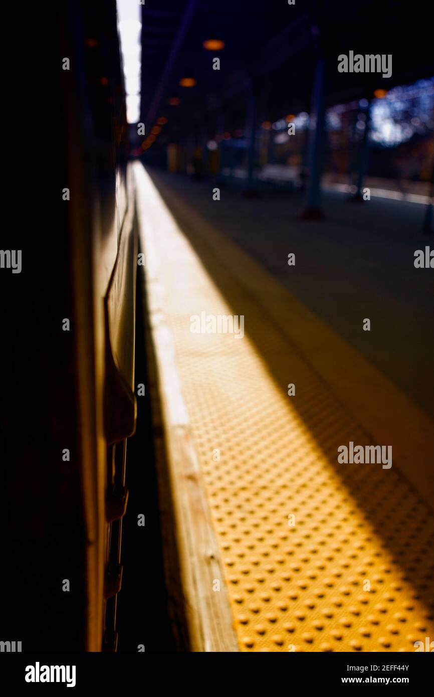 Train at a railroad station platform Stock Photo - Alamy