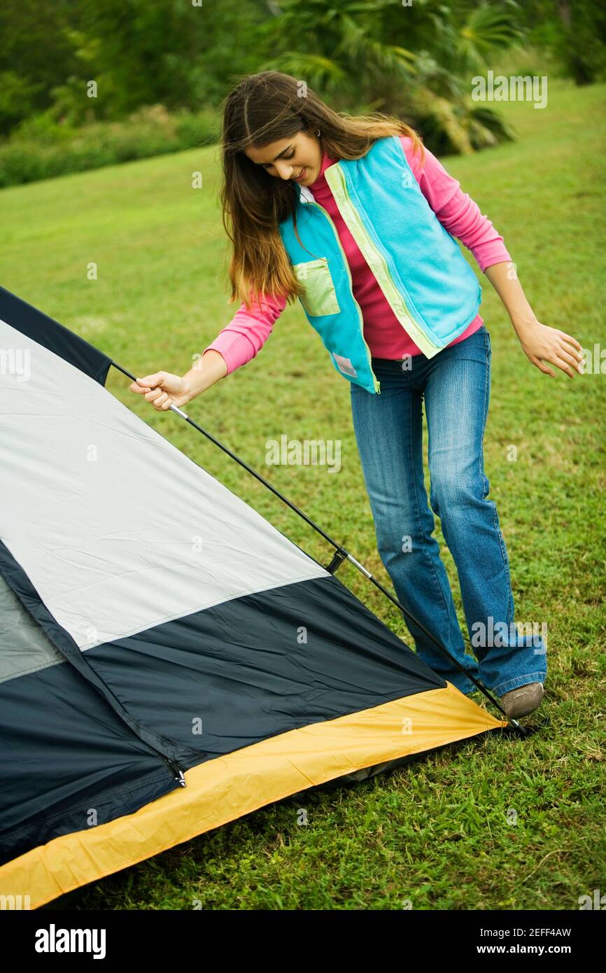 Girl adjusting a tent Stock Photo - Alamy
