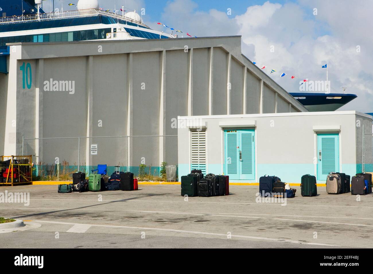 Luggage in front of an industrial building Stock Photo - Alamy